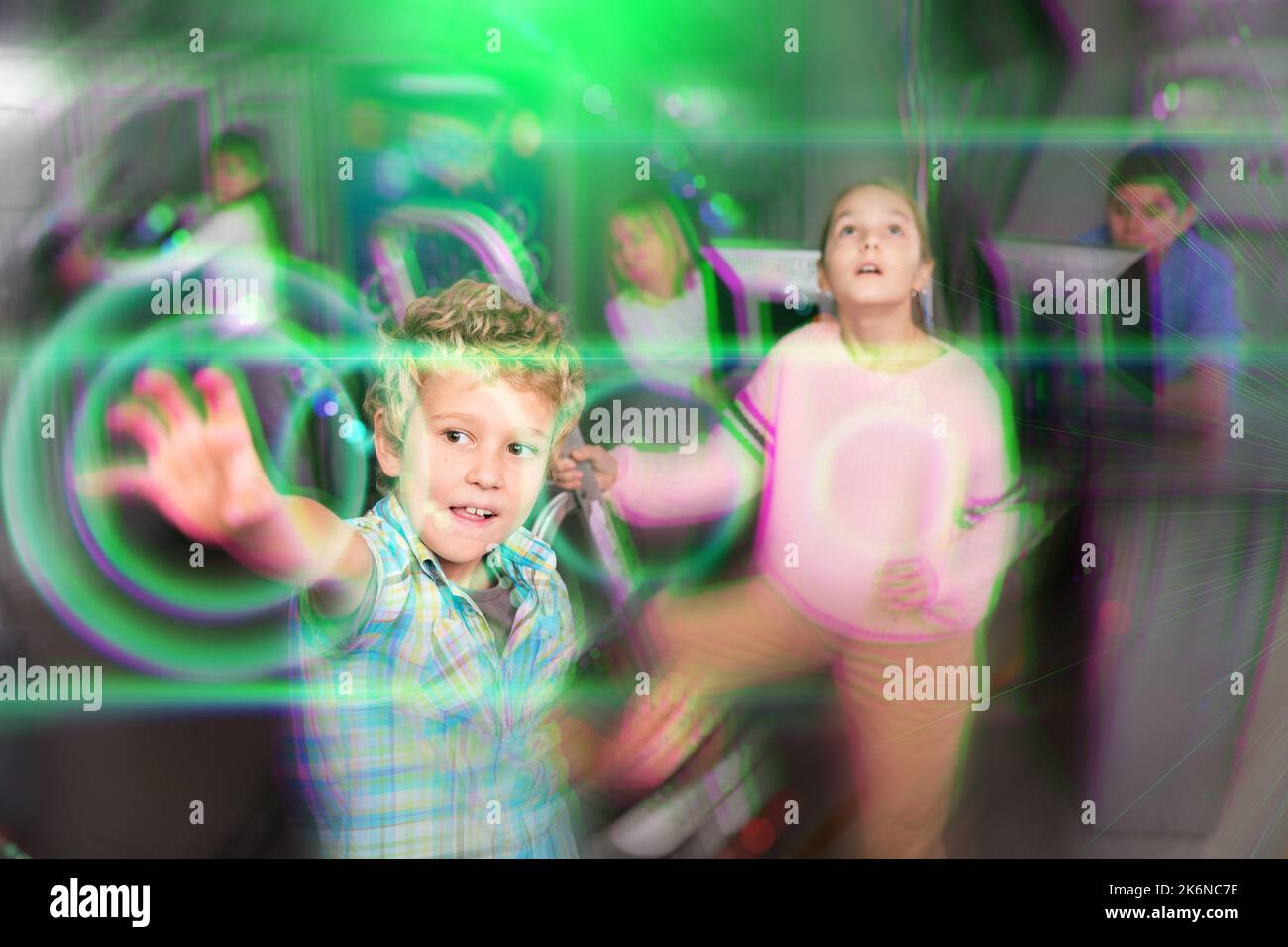 Tween boy reaching for something in quest room, toned image Stock Photo ...