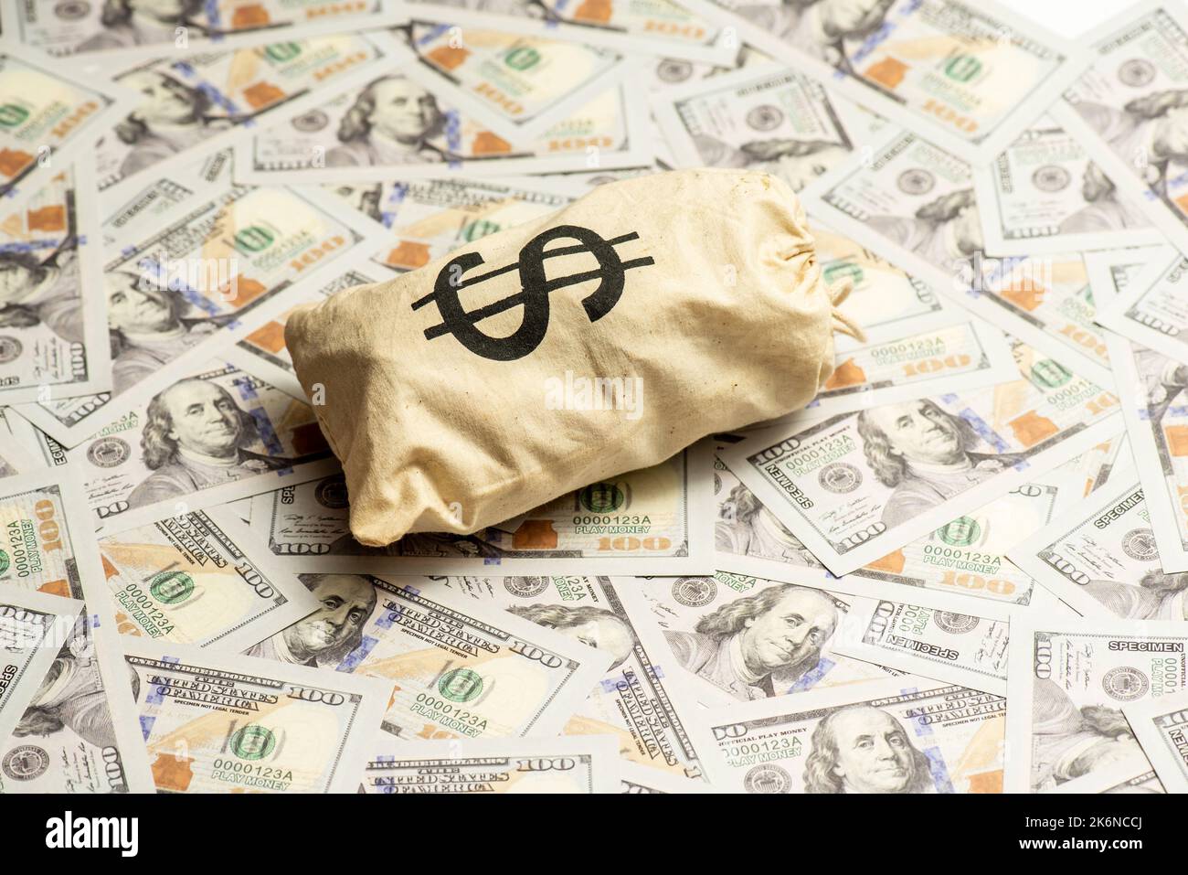 Dollar sign money bag against us currency Stock Photo - Alamy