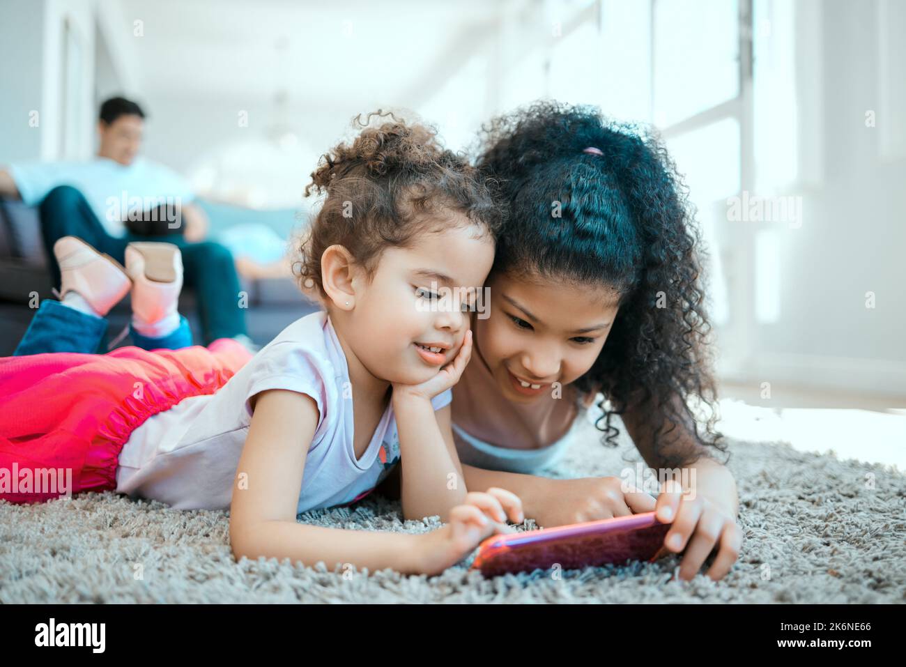 Some days are better together. two sisters using a digital tablet at ...