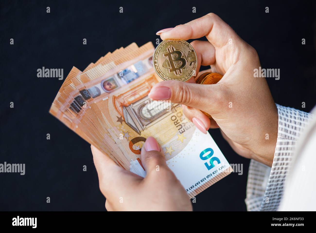 Closeup womans hands holding gold coins of crypto currency and euro ...