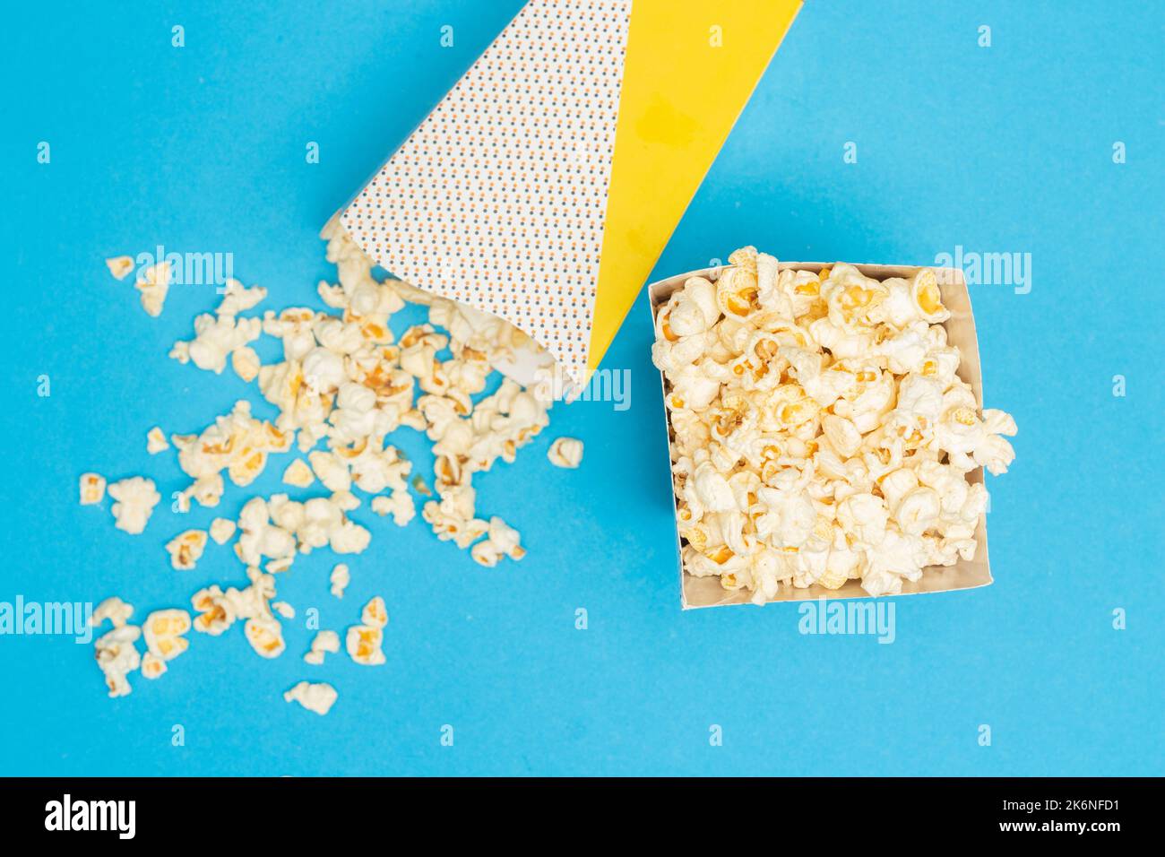 Snack concept, Sweet popcorn in paper cup and spill out from paper cup ...