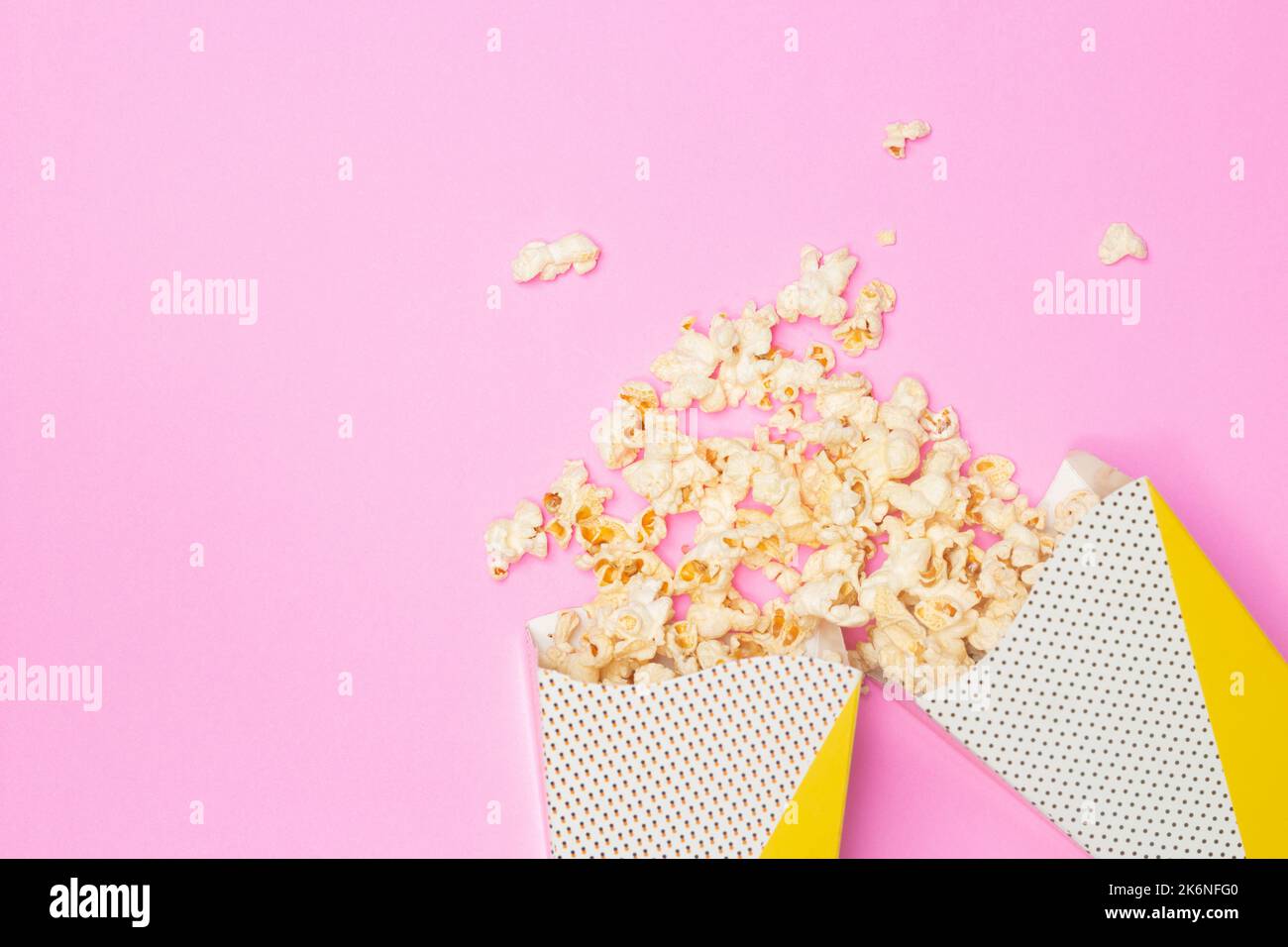 Snack concept, Sweet popcorn float out from two paper cup on pink ...