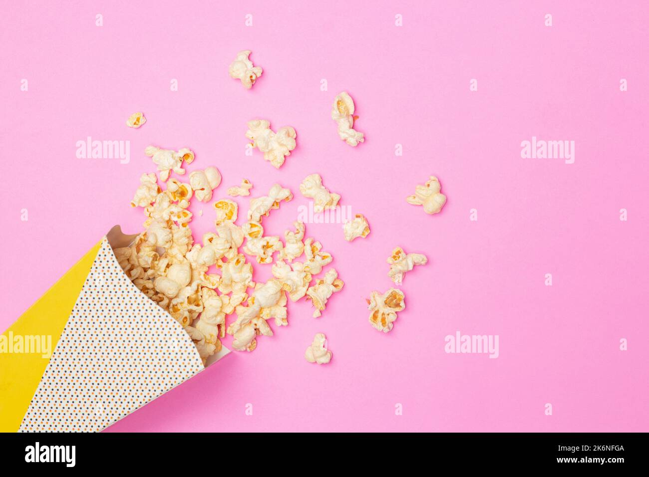 Snack concept, Sweet popcorn float out from paper cup on pink ...
