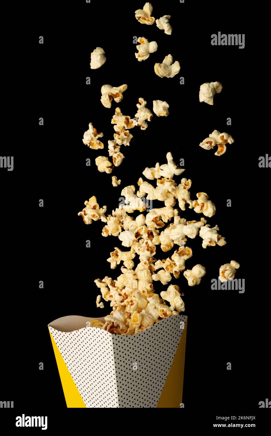 Snack concept, Sweet popcorn floating out from paper cup on pink ...