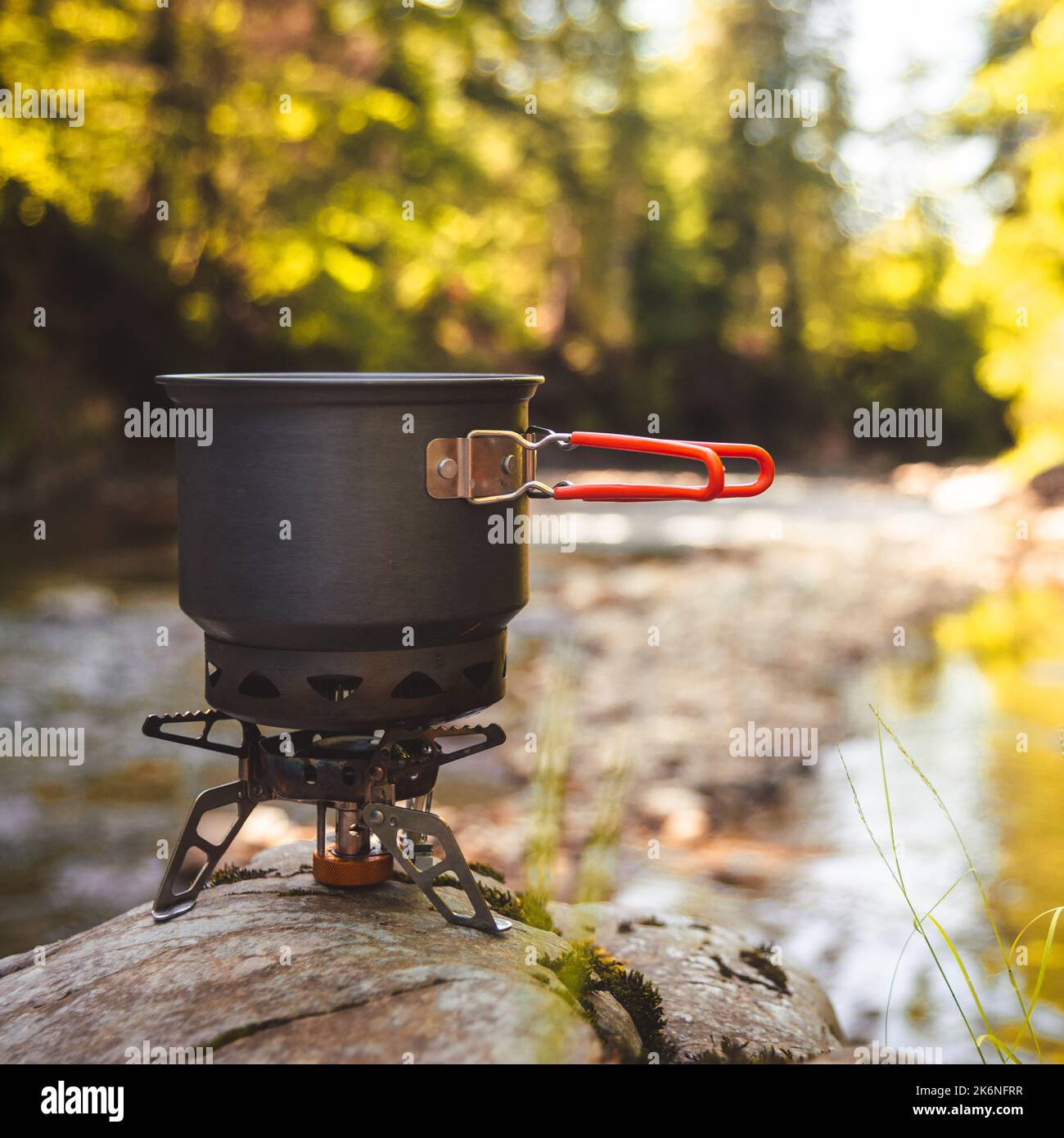 Cooking food using camping gas during the hike. River. Carpathians ...