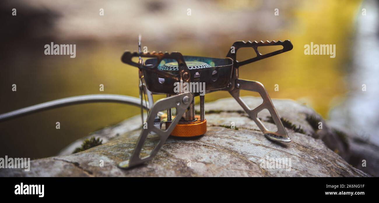 Cooking food using camping gas during the hike Stock Photo - Alamy