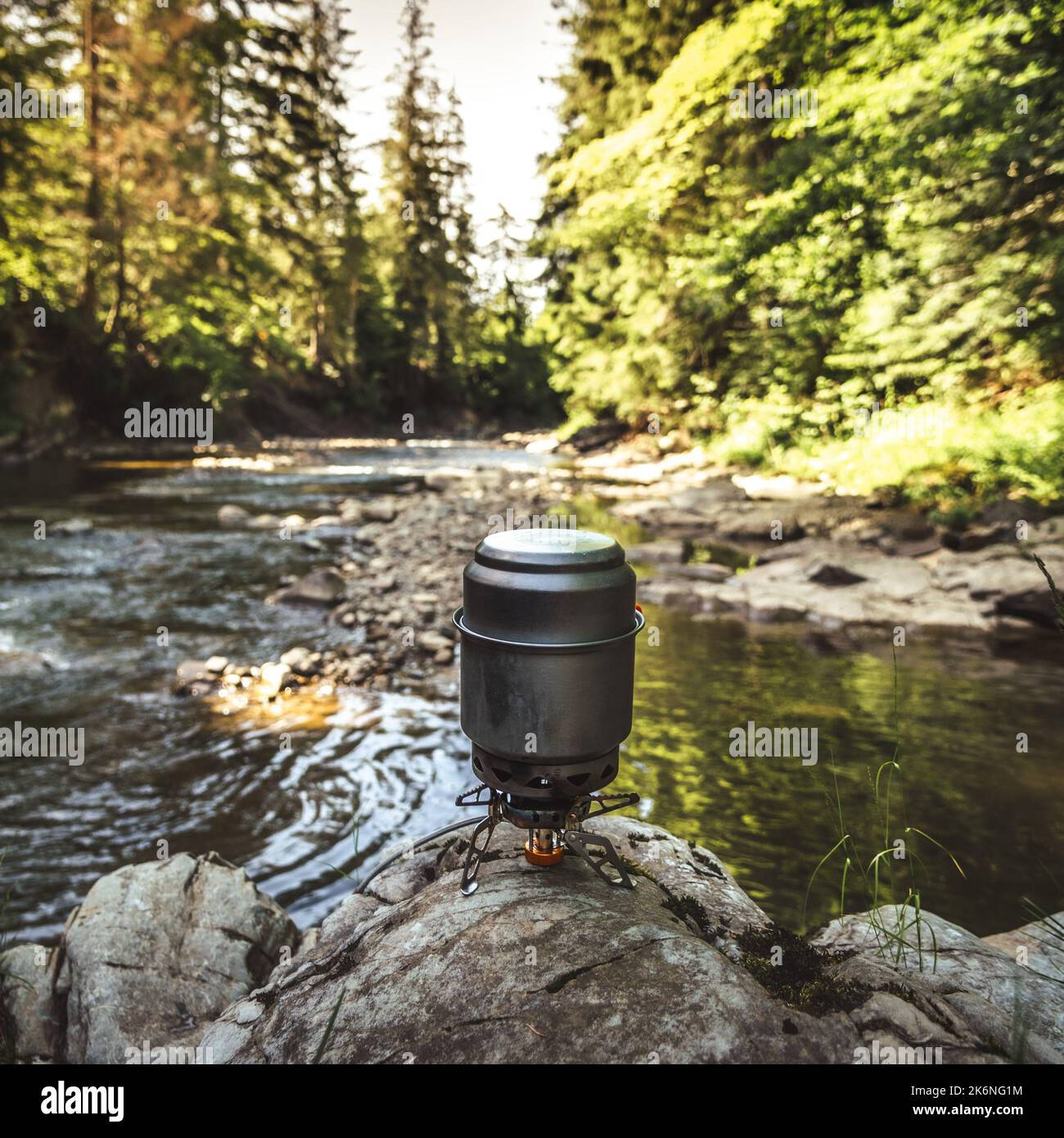 Cooking food using camping gas during the hike Stock Photo - Alamy