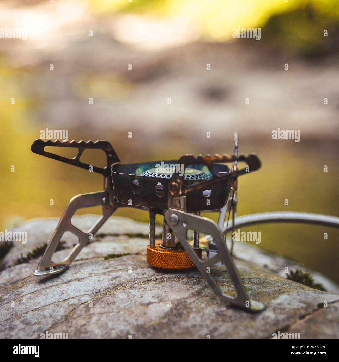 Cooking food using camping gas during the hike Stock Photo - Alamy