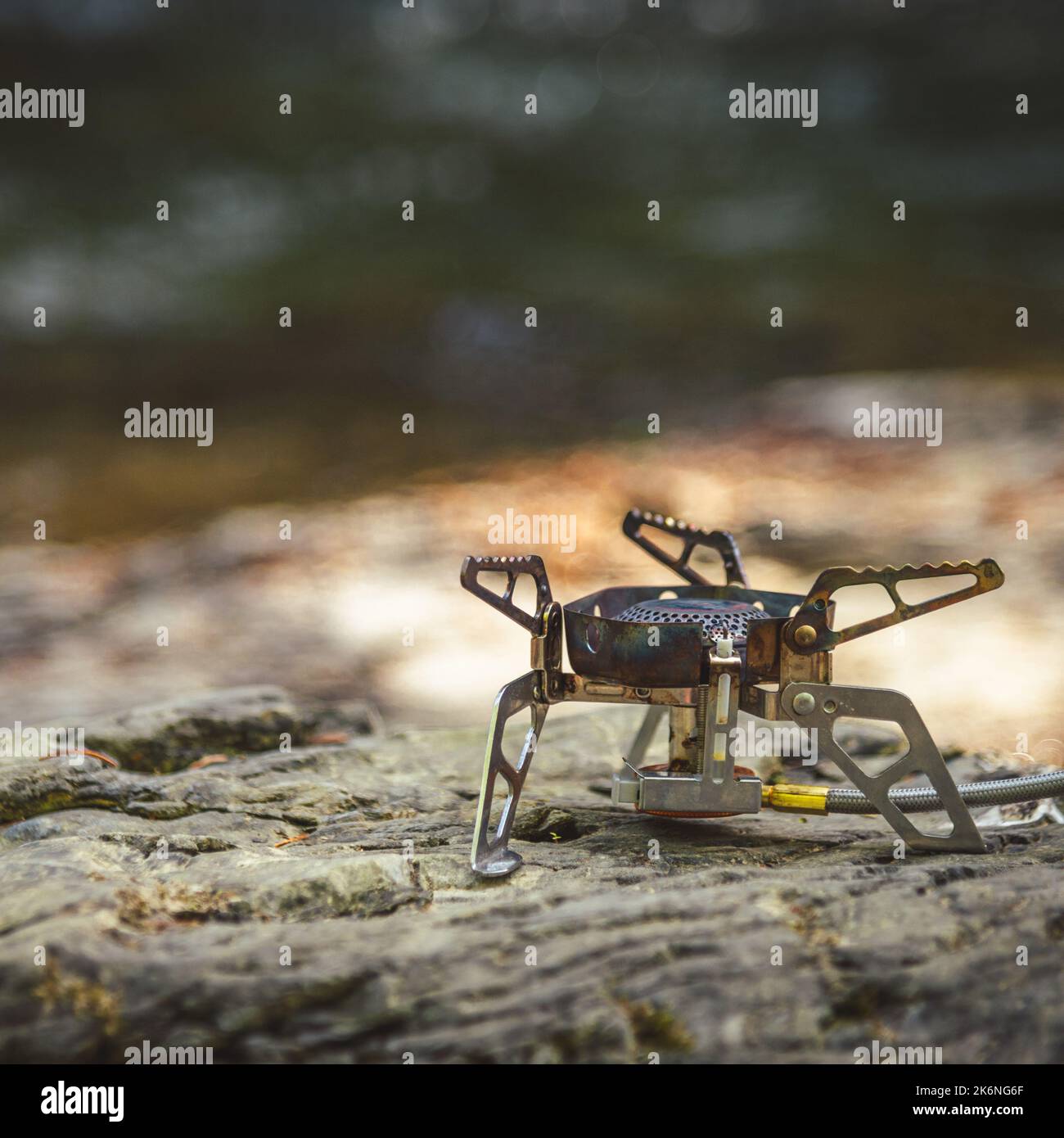 Cooking food using camping gas during the hike Stock Photo - Alamy