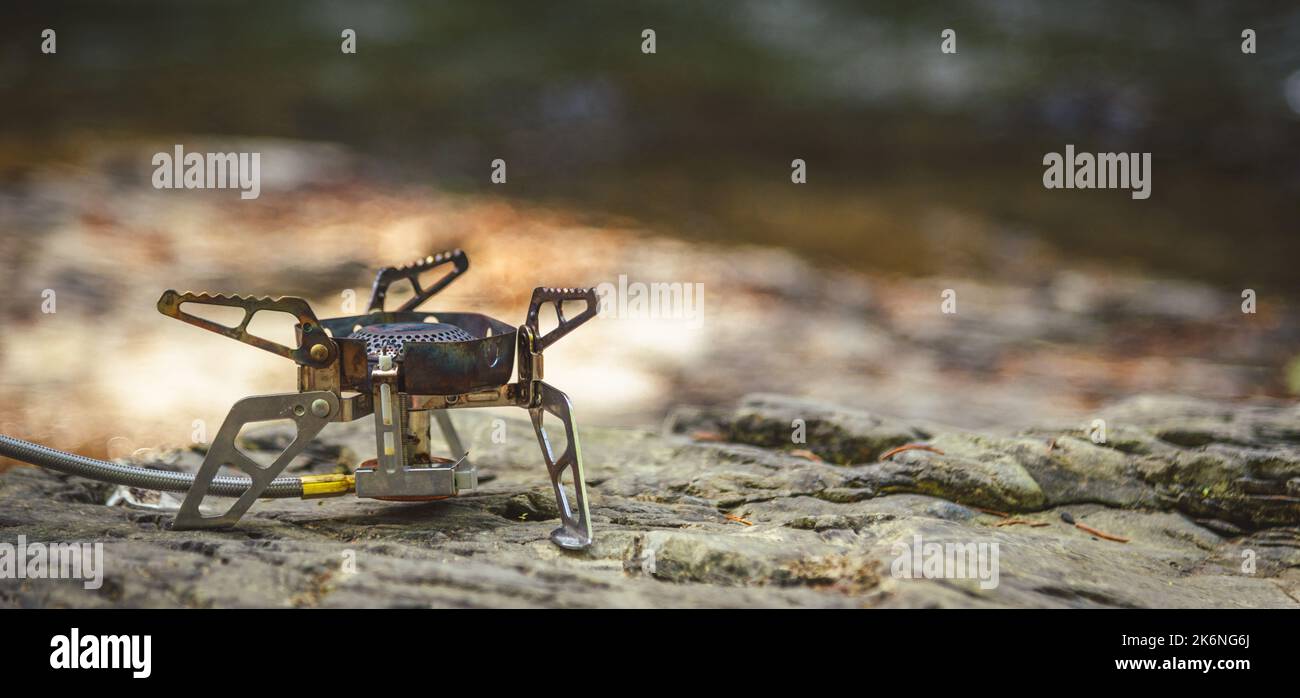 Cooking food using camping gas during the hike Stock Photo - Alamy