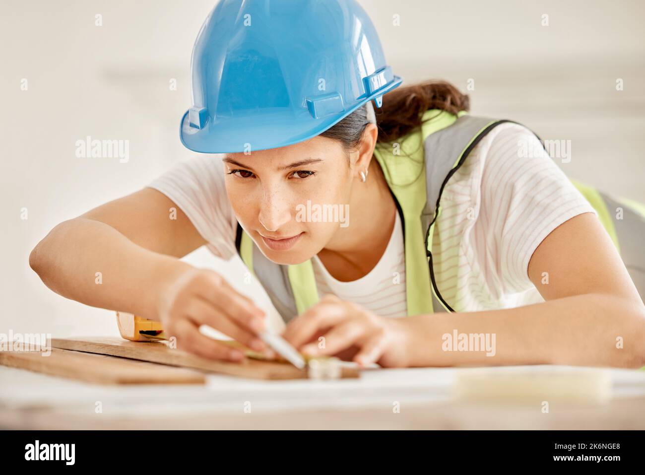 Making sure it all lines up perfectly. an attractive young construction ...