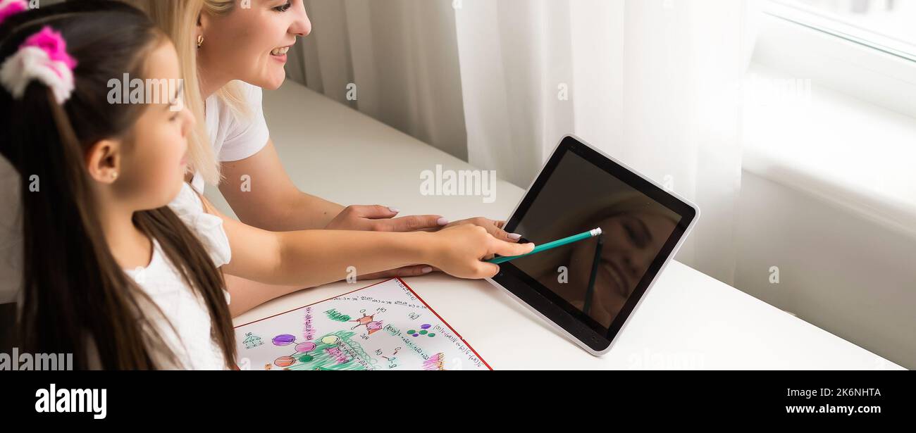 Online education of children. Mother and daughter of preschool watching ...