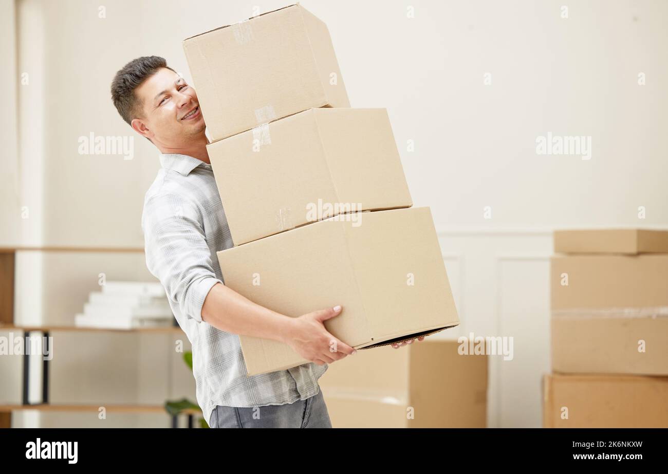 Never been this happy to move boxes. a handsome young man carrying ...