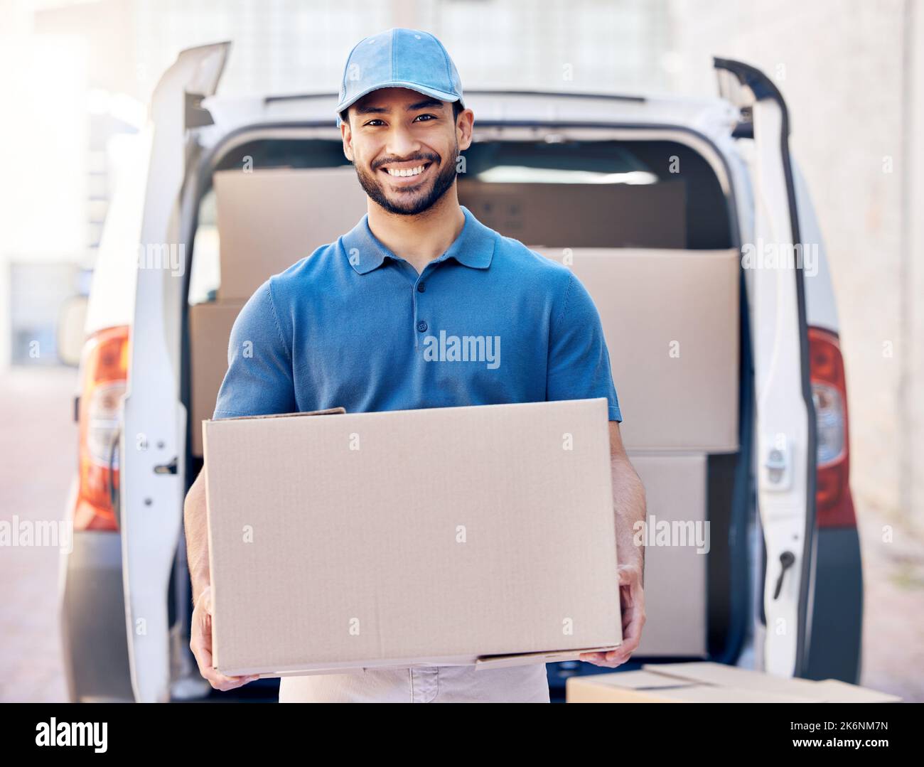 When we give, we receive. a delivery man standing by his van Stock ...