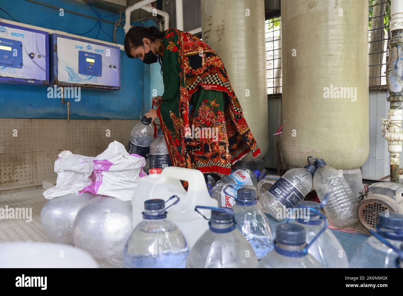Dhaka, Bangladesh. 14th Oct, 2022. People collect water from a water ...