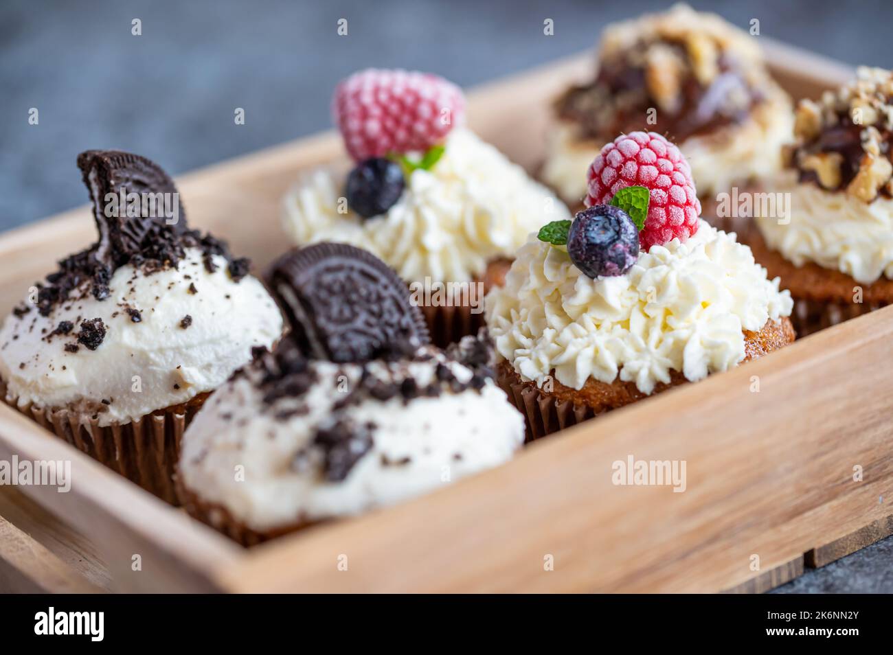 Tasty sweet muffins with mascarpone creme and chocolate, raspberry and ...
