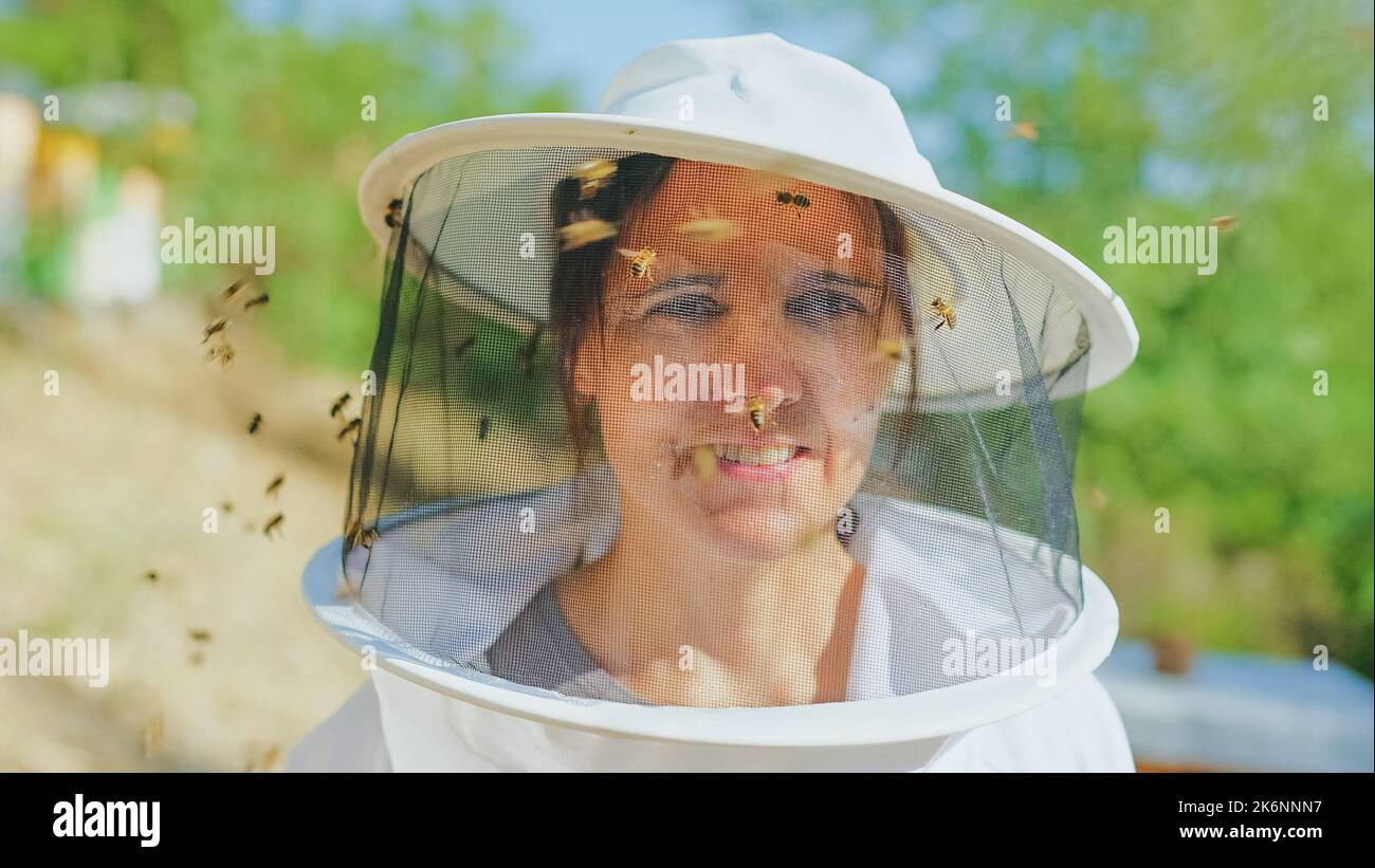 Bees flying around the face of a beekeeper Stock Photo - Alamy
