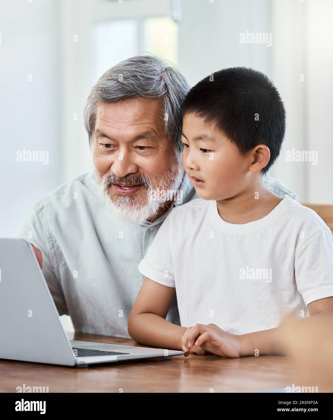 Learning can be fun. a grandfather helping his grandchild with his ...