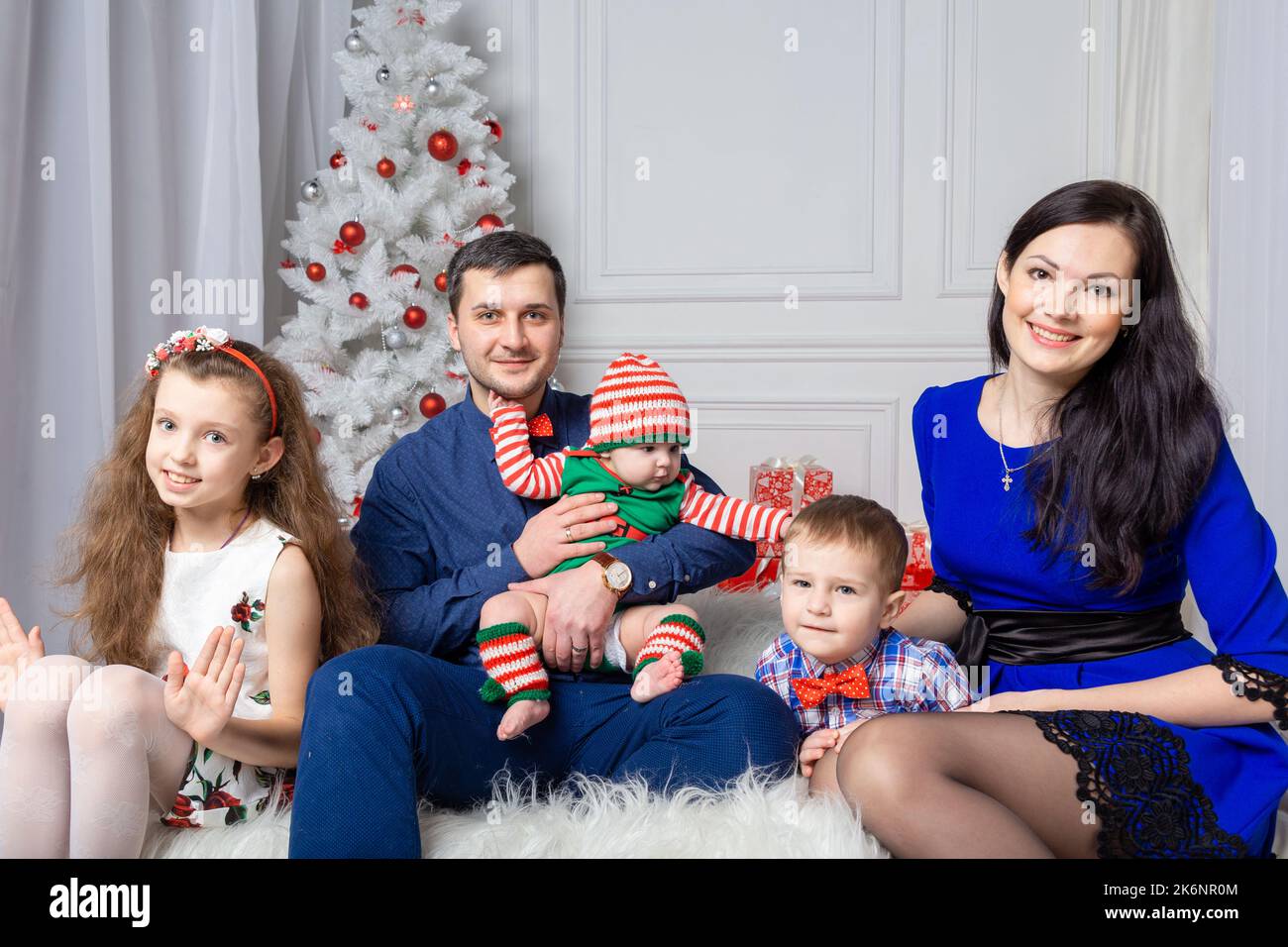 Parents with kids in a Christmas photo session. Studio shooting before ...