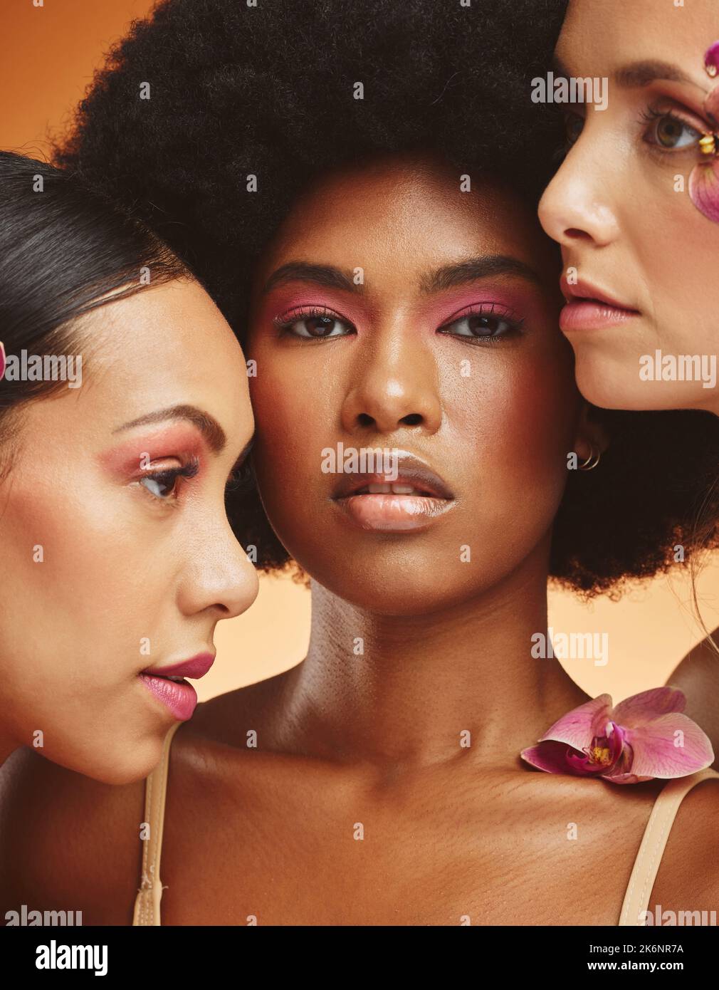 Beauty, flower and group of women with makeup in studio, model for ...