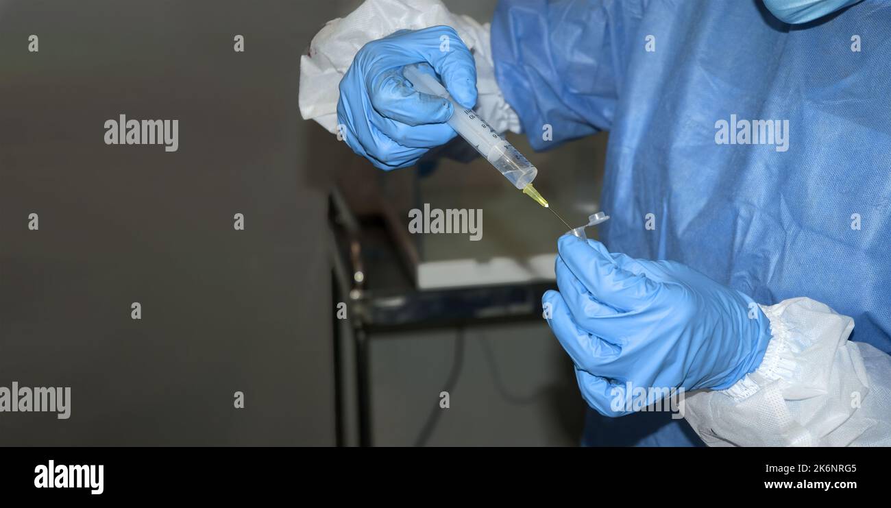 The medical examiner, forensic, surgeon, collects trace fluids with a ...