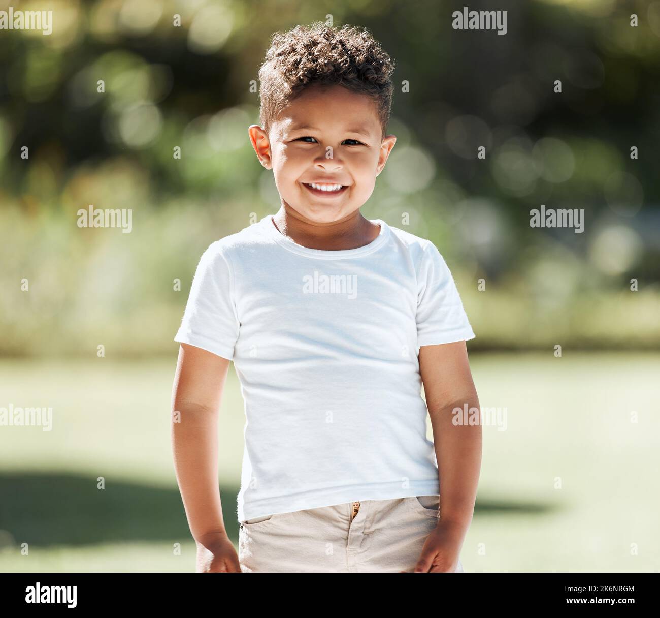I love playing outside. an adorable little boy standing outside Stock ...