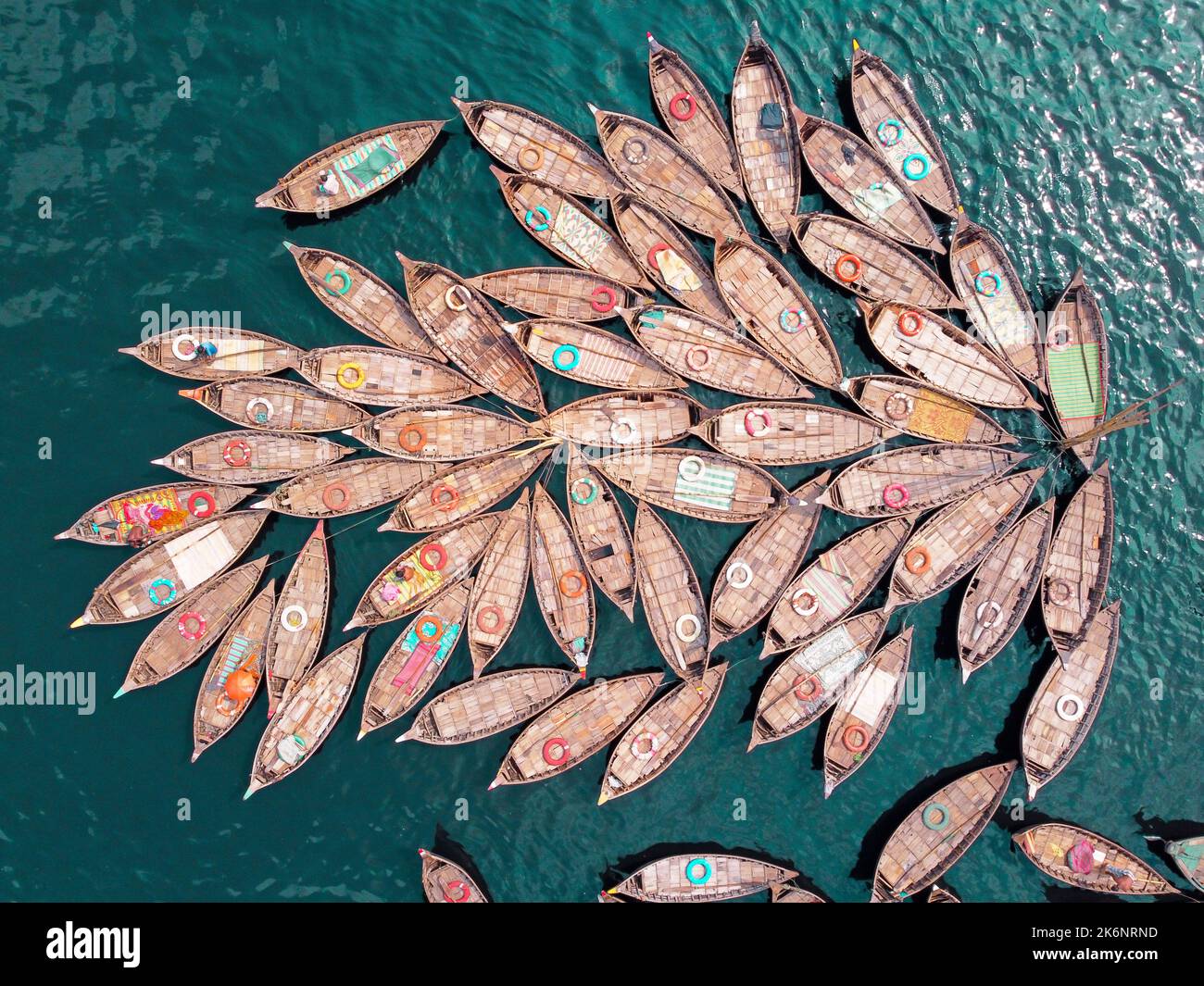 Hundreds of wooden boats fan out around their moorings in patterns ...
