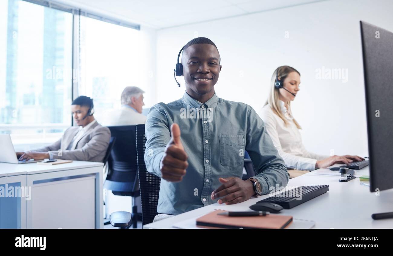 Thanks for calling the best. a young businessman using a headset and ...