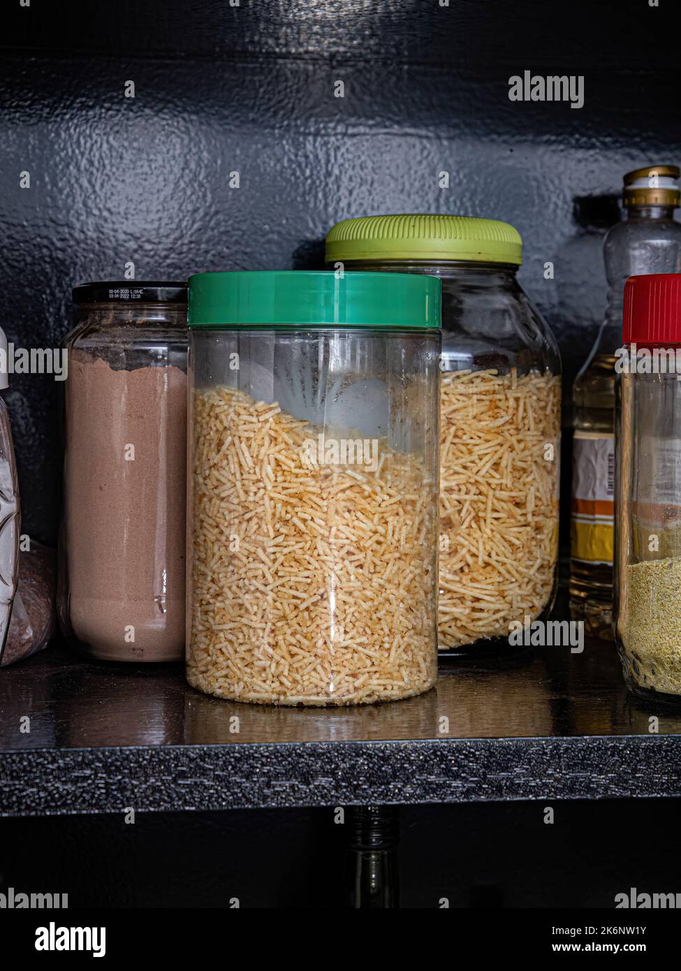 clear plastic pot with potato straw inside Stock Photo - Alamy