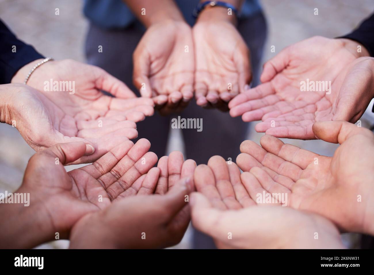 Prayer brings us together. a group of people holding out their palms in ...