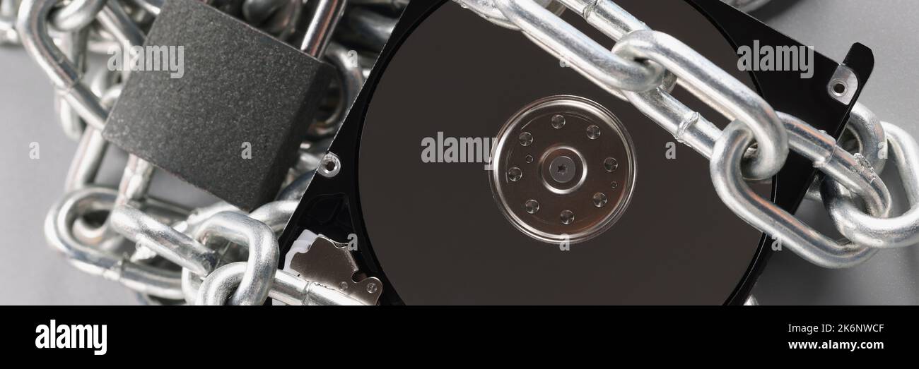 The hard drive is wrapped with a chain with a padlock Stock Photo - Alamy