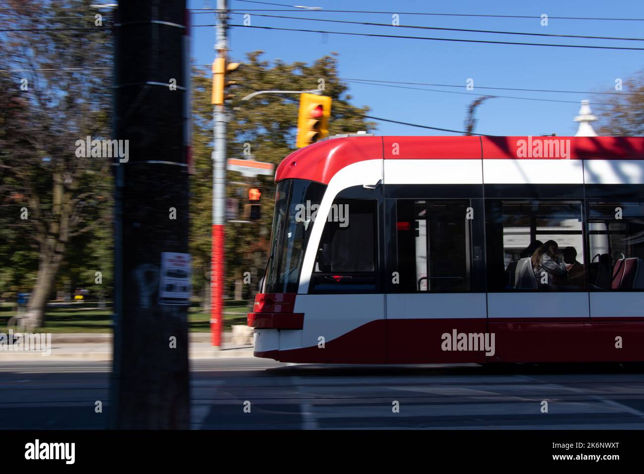 A modern streetcar, light rail, is seen on a downtown city street ...