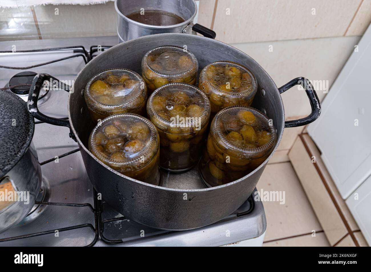 Glass jars with mangaba jam inside in a pan Stock Photo - Alamy