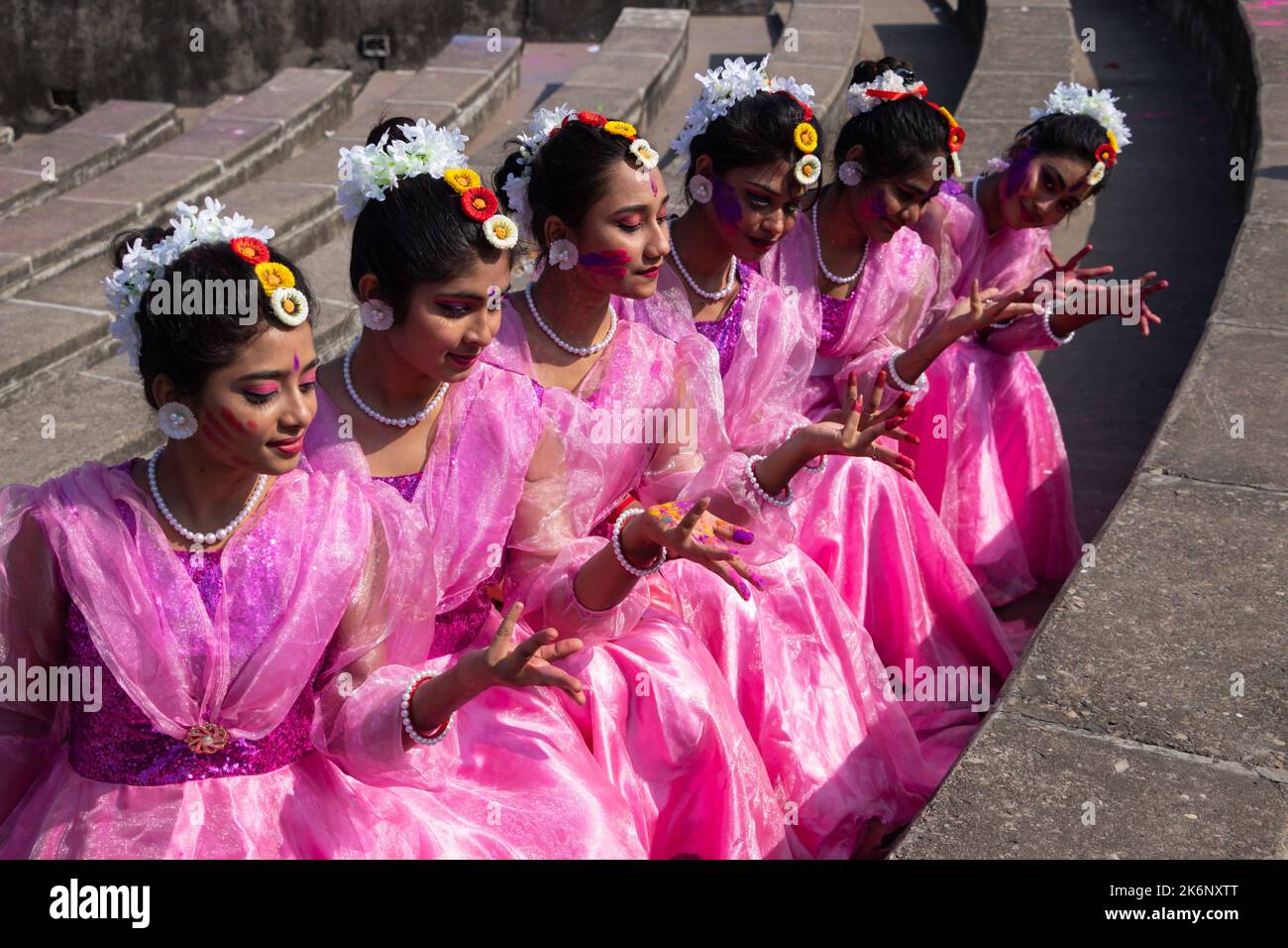 Women wear traditional dresses with floral ornaments and perform during ...