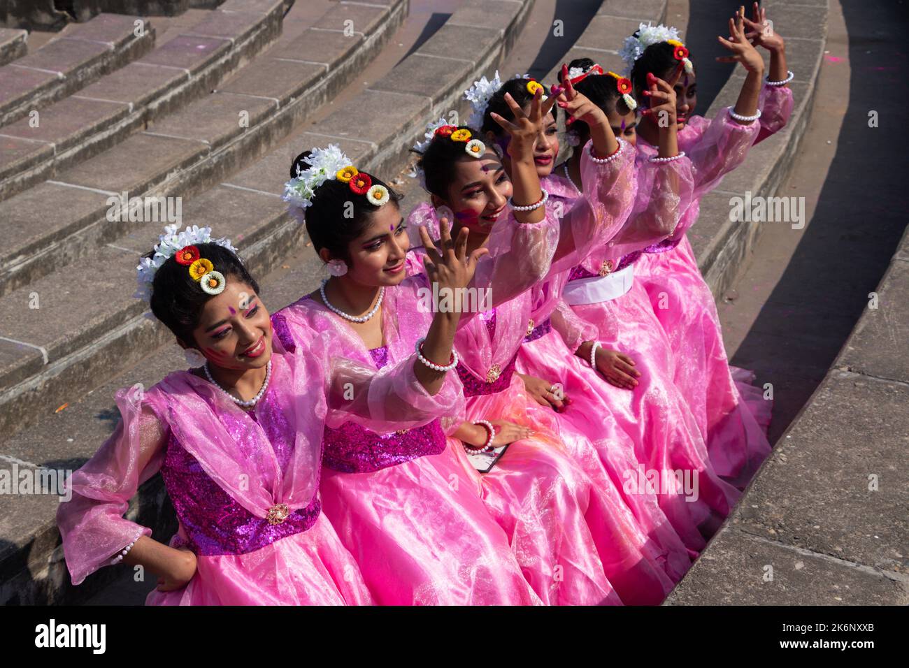 Women wear traditional dresses with floral ornaments and perform during ...