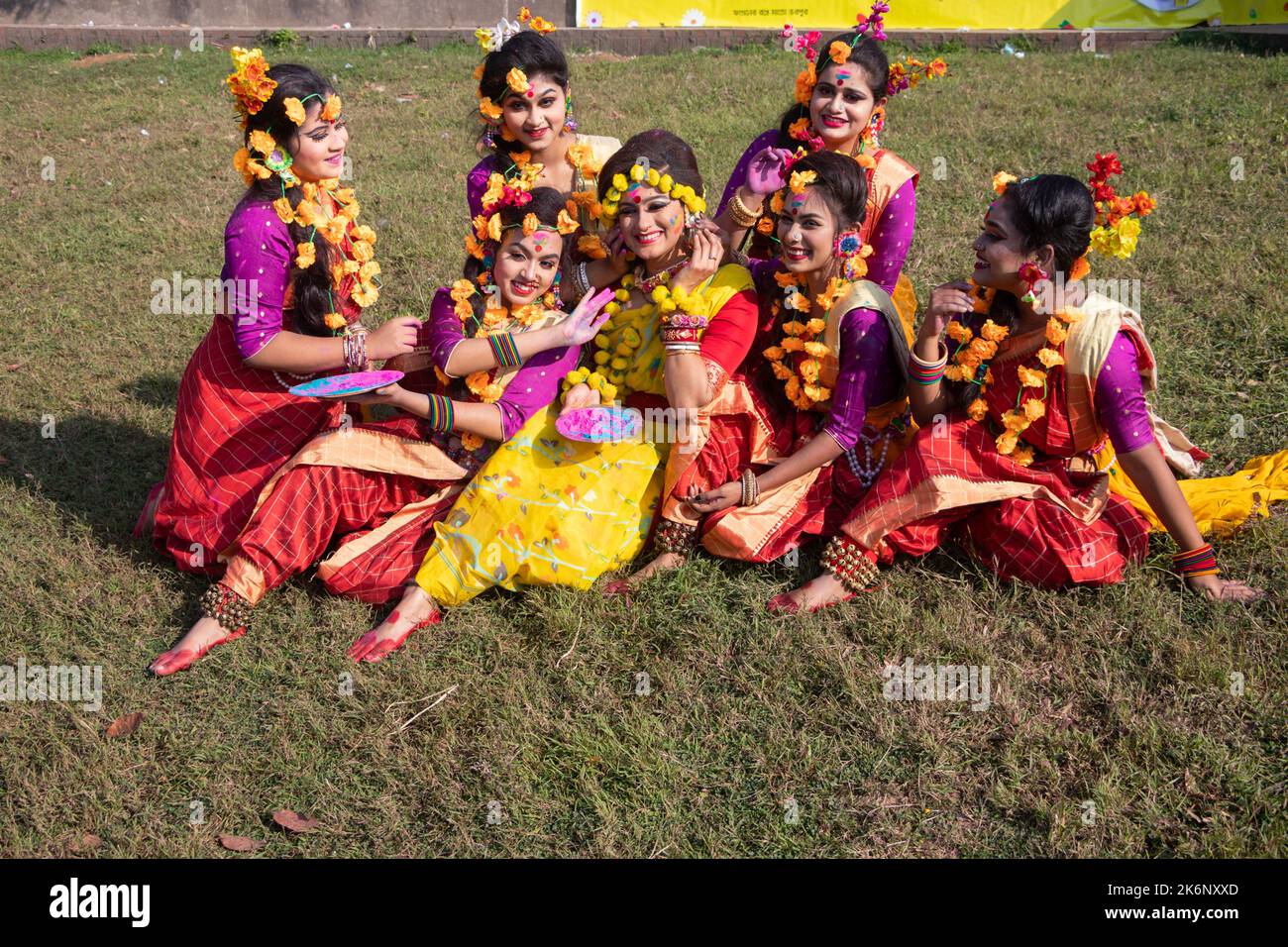 Women wear traditional dresses with floral ornaments and perform during ...