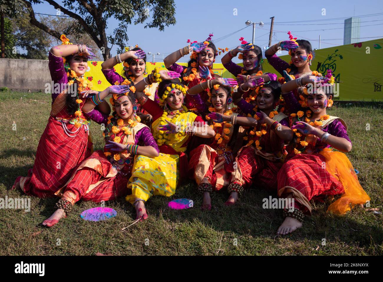 Women wear traditional dresses with floral ornaments and perform during ...