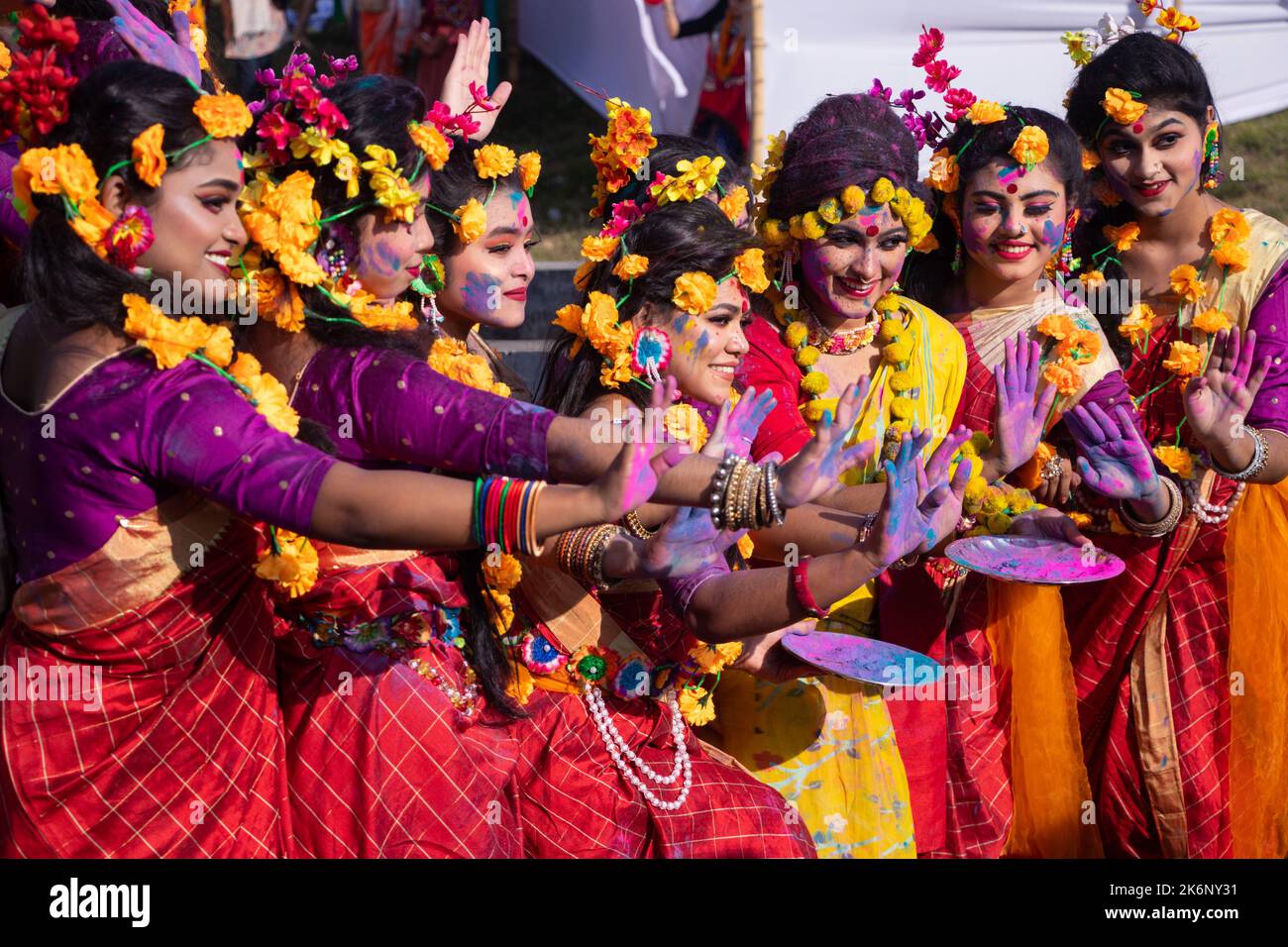 Women wear traditional dresses with floral ornaments and perform during ...