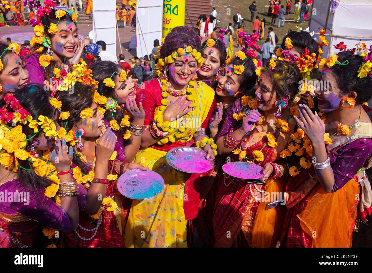 Women wear traditional dresses with floral ornaments and perform during ...