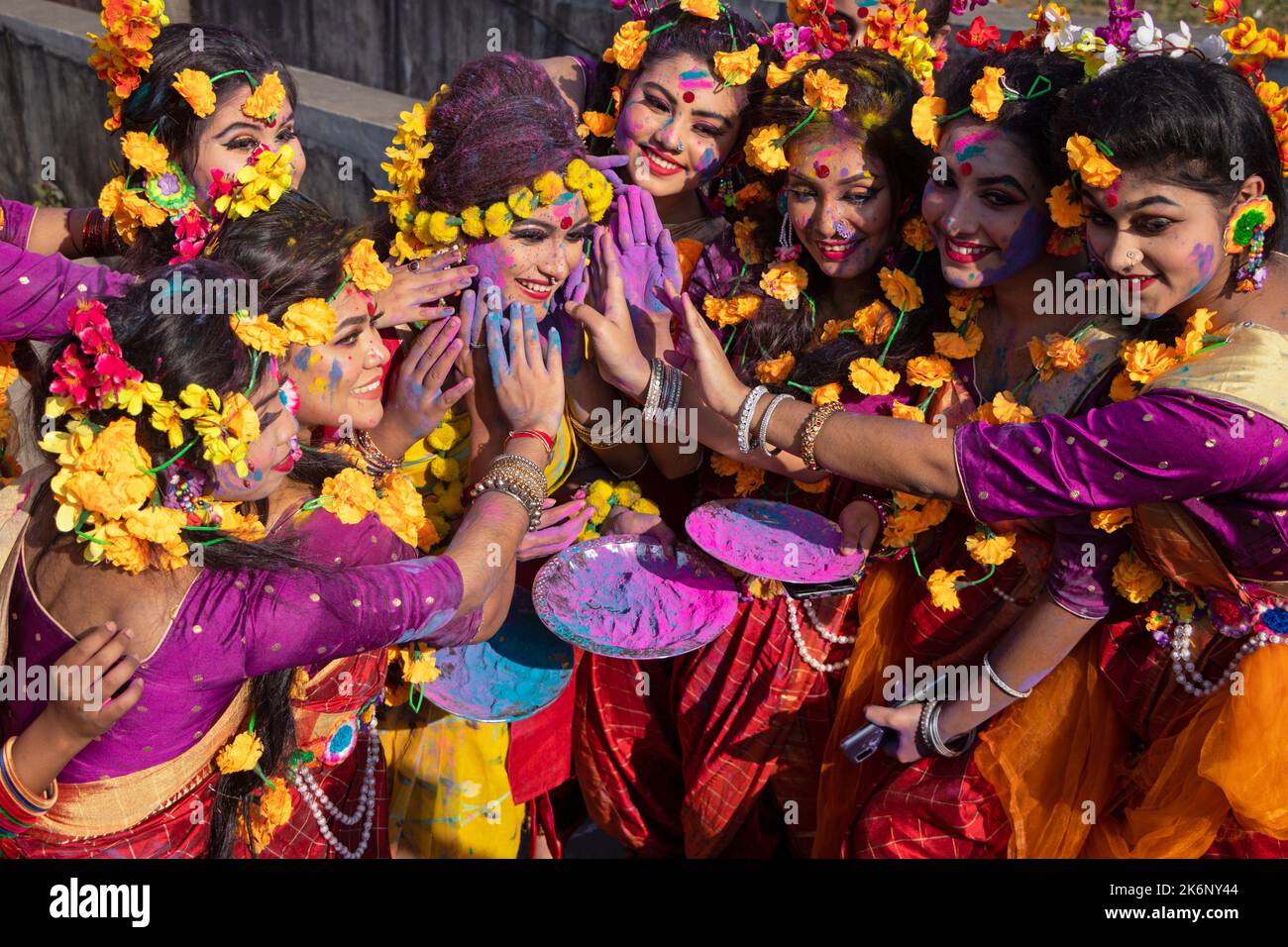 Women wear traditional dresses with floral ornaments and perform during ...