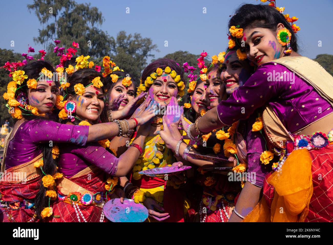 Women wear traditional dresses with floral ornaments and perform during ...