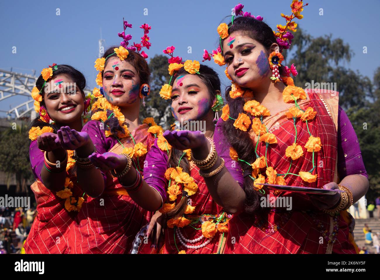 Women wear traditional dresses with floral ornaments and perform during ...