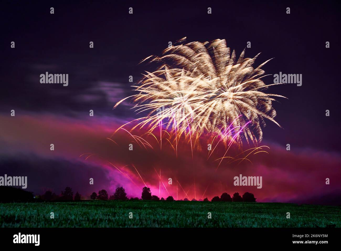 Fireworks with blue stars and yellow fountains against dark night sky ...