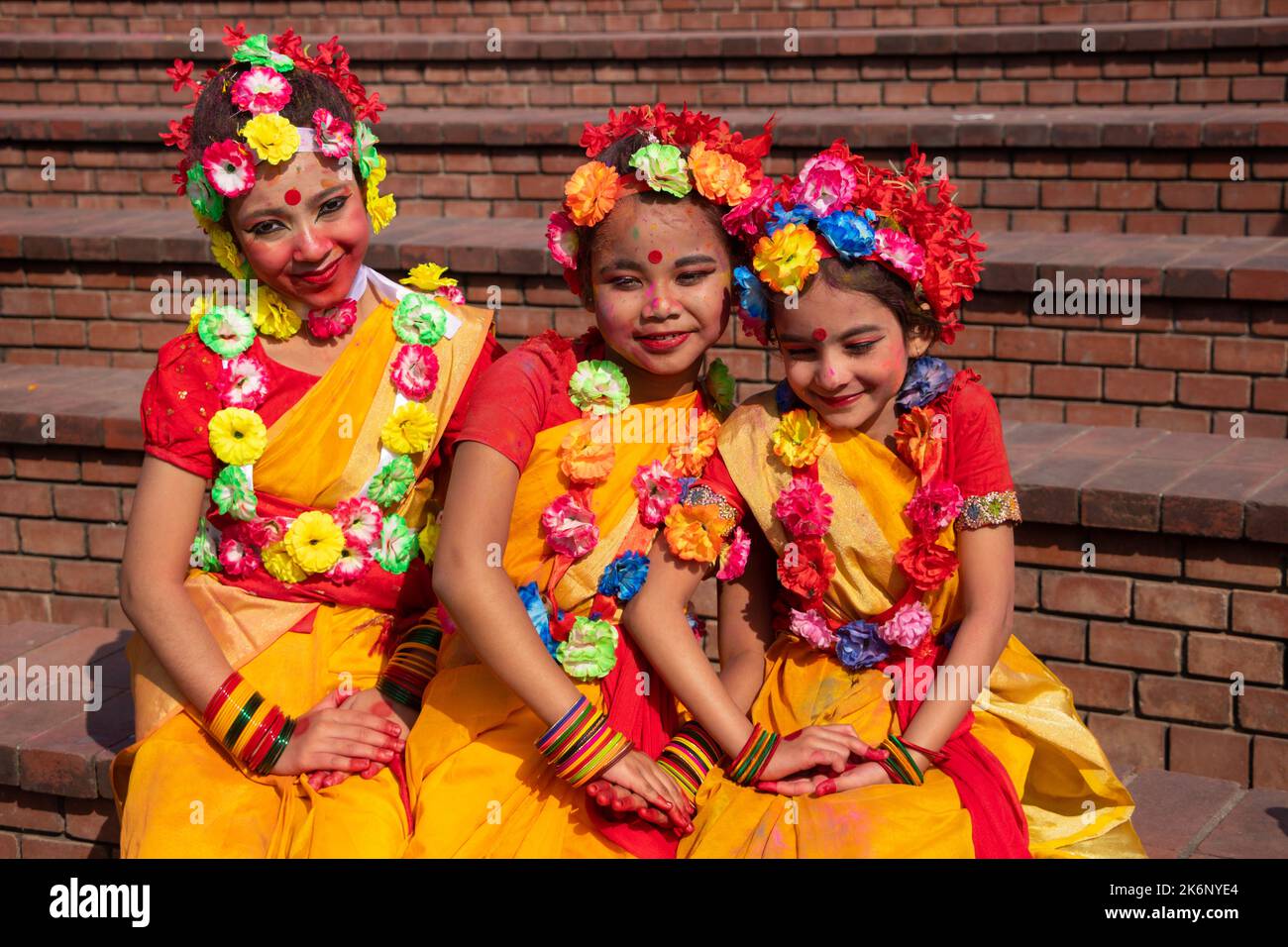 Women wear traditional dresses with floral ornaments and perform during ...