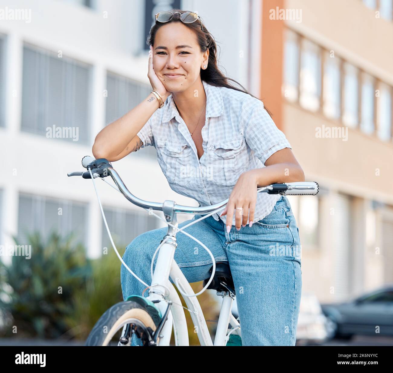 Bike, travel and city with a woman tourist riding her bicycle in a town ...