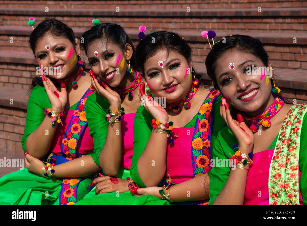 Women wear traditional dresses with floral ornaments and perform during ...