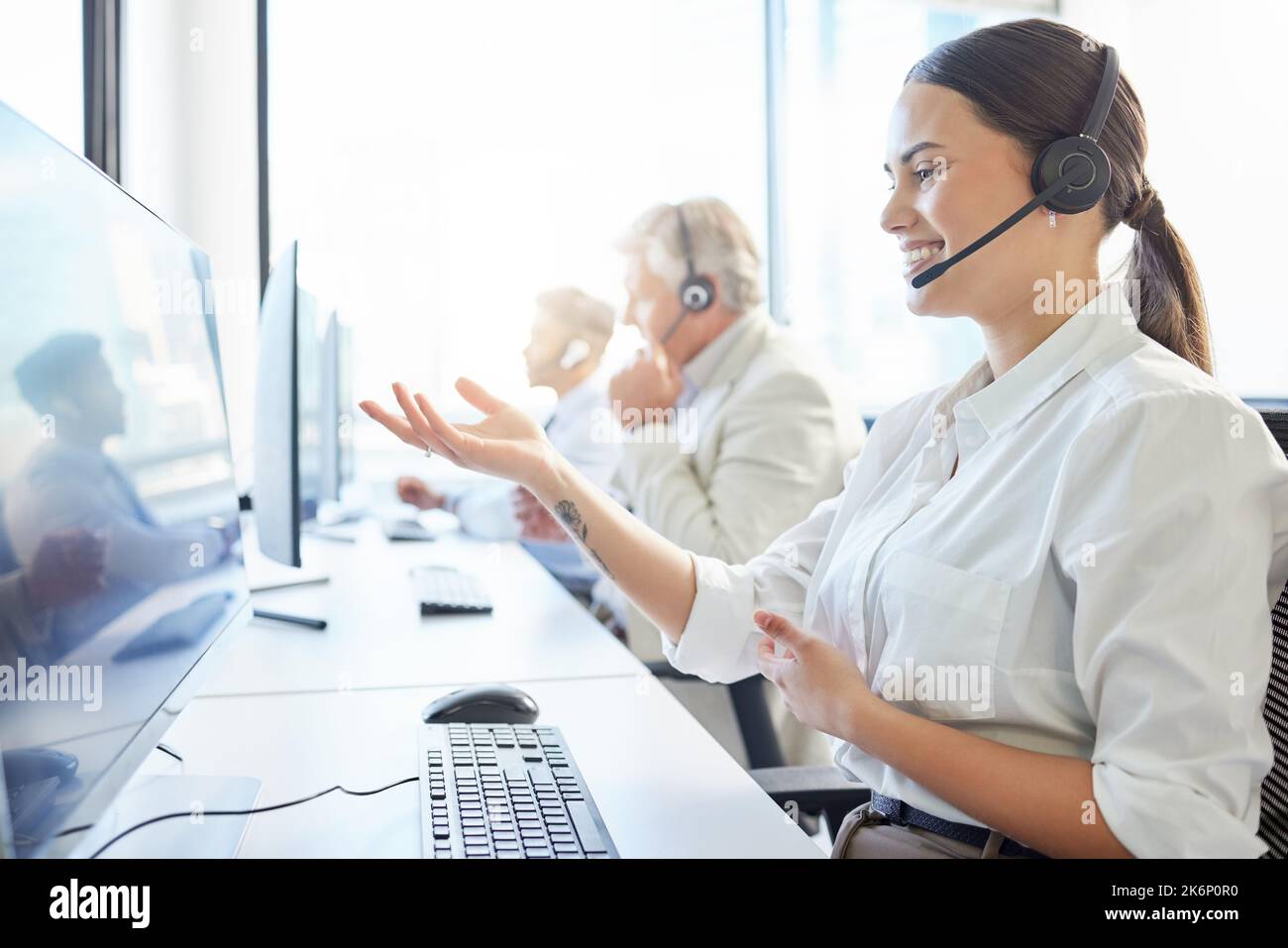 I have some good news for you. a young woman wearing a headset while ...