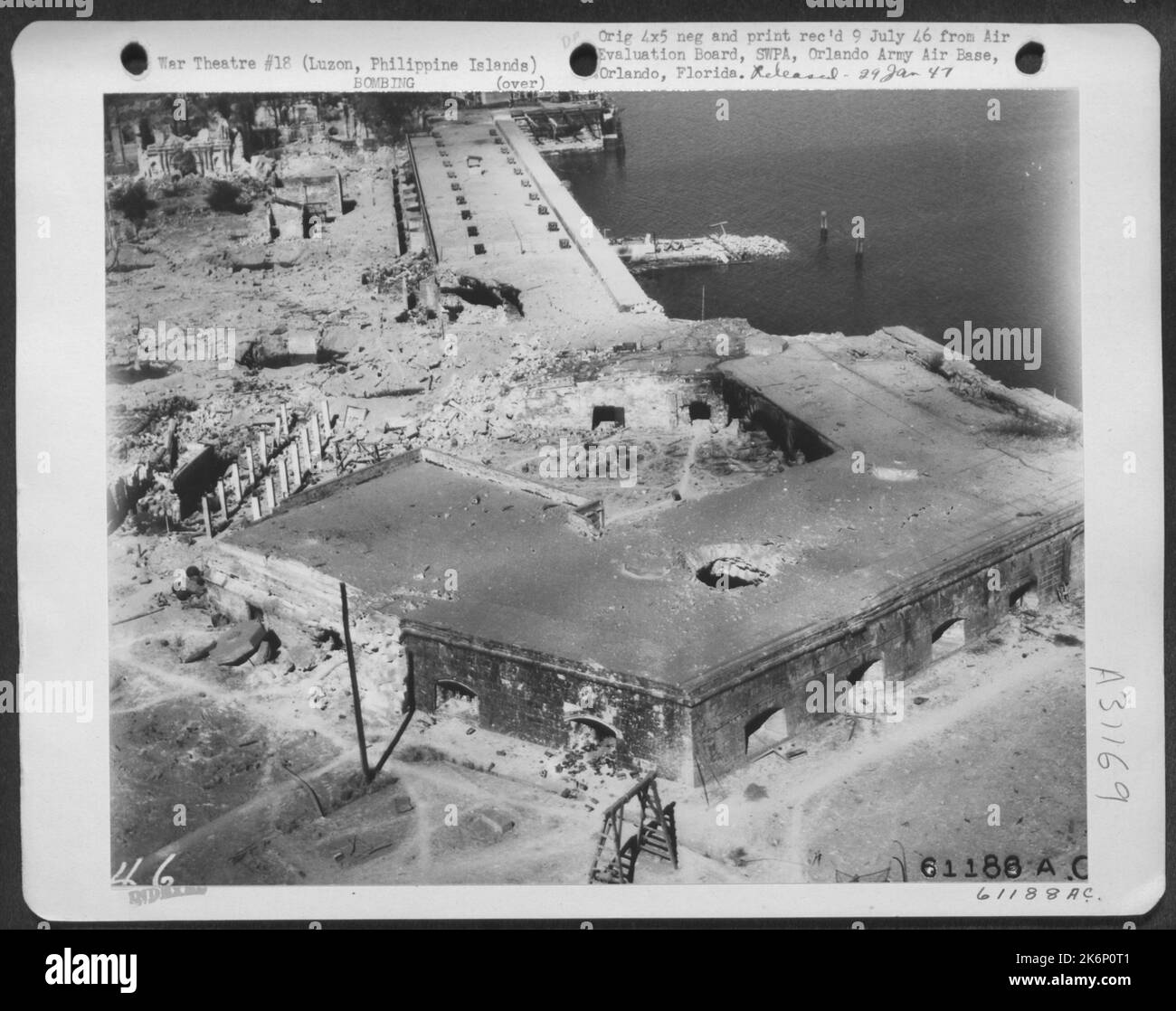 Crater hole in roof 5 feet thick. Cavite, Luzon Island, Philippine ...