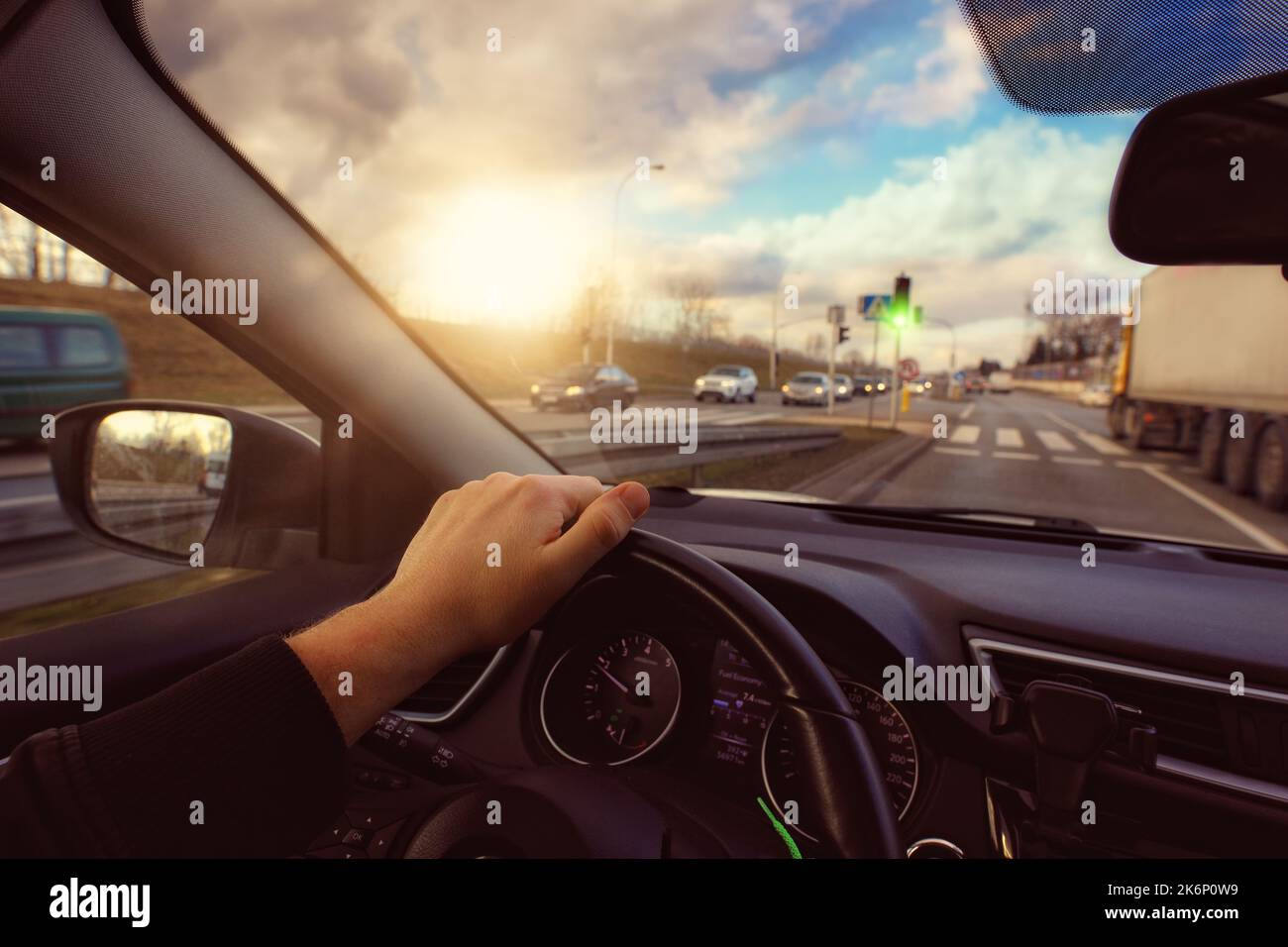 Driving a car through the streets of the city on a warm and sunny day ...