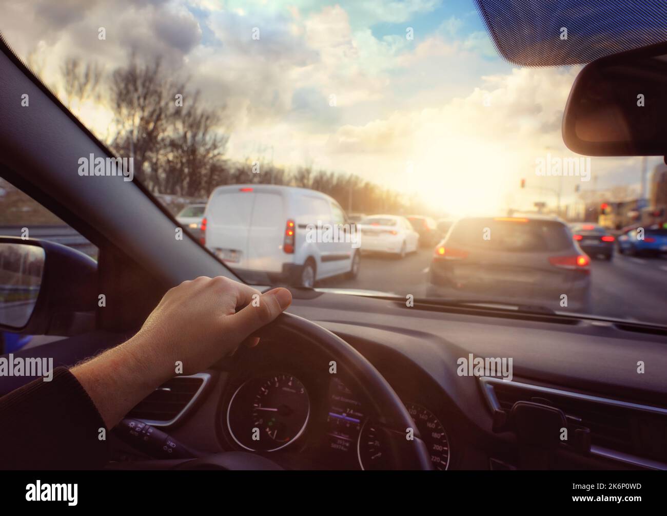 Driving a car through the streets of the city on a warm and sunny day ...